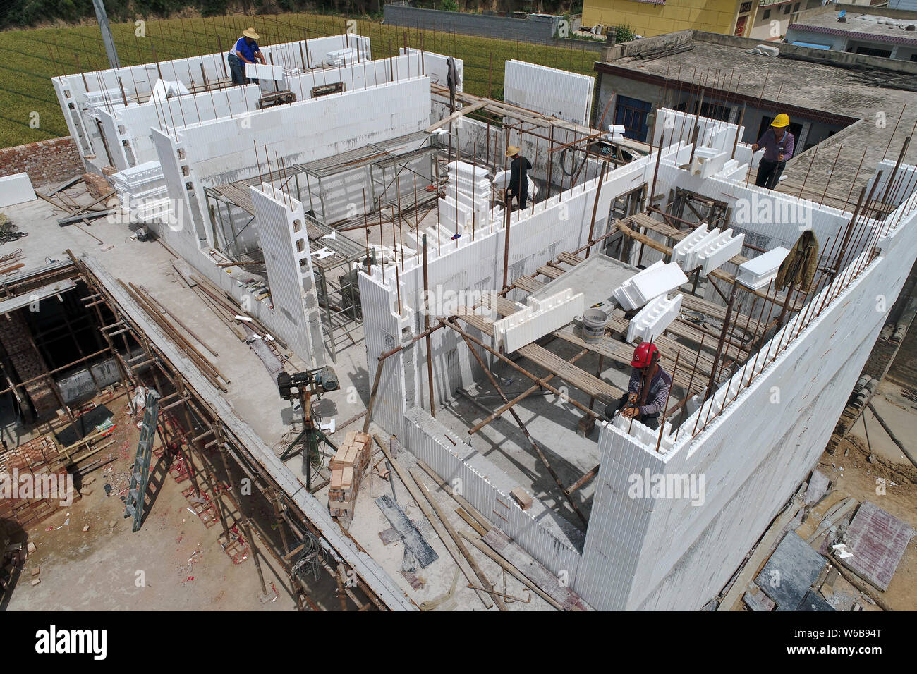 Chinese workers use expanded Polystyrene (EPS) foam to build houses in ...