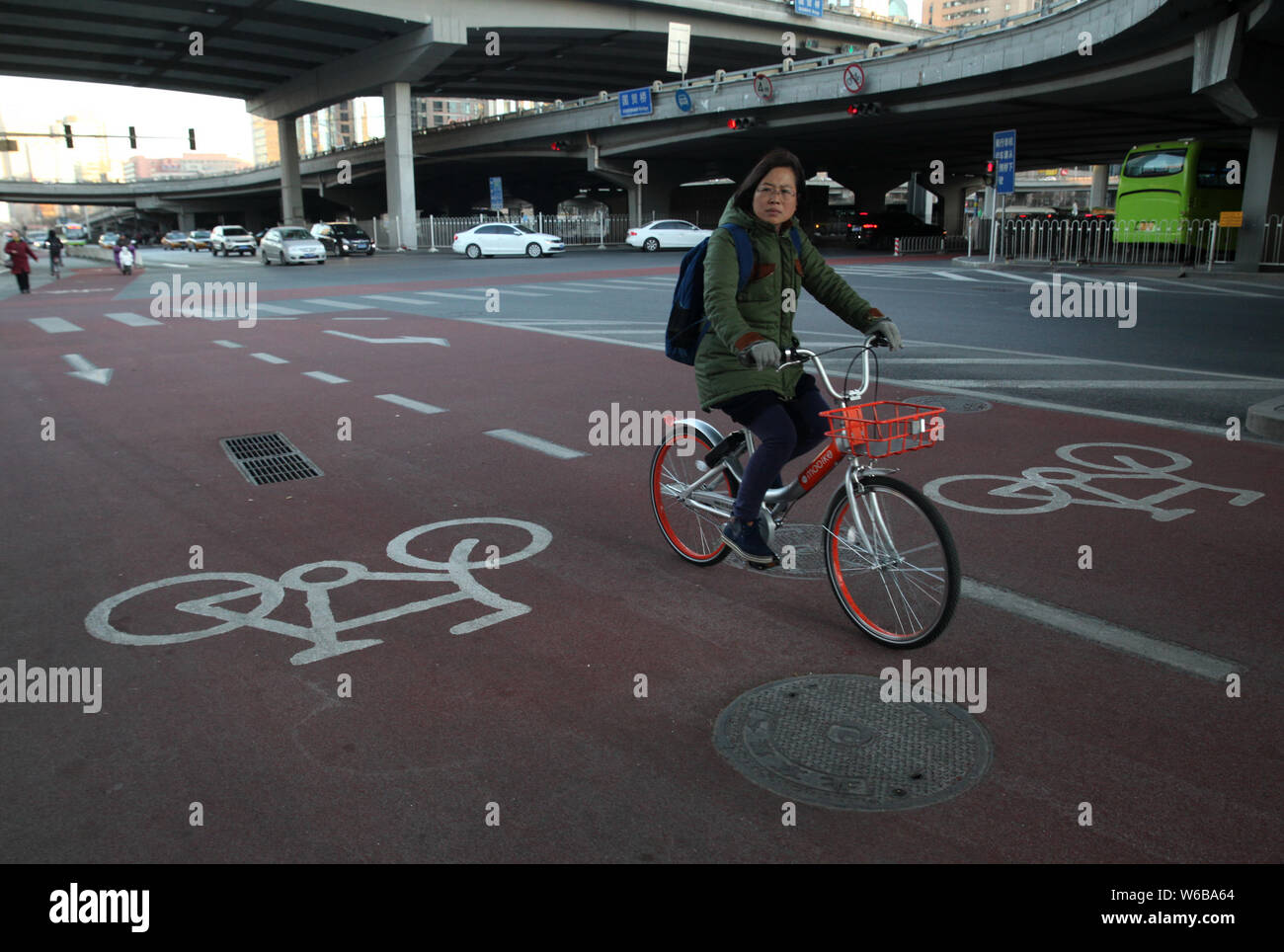 --FILE--A cyclist rides on a bicycle lane in a street under Guomao ...