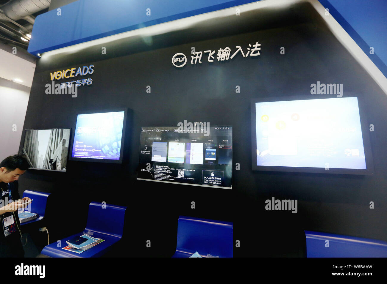 --FILE--A Chinese employee is seen at the stand of IFlytek Co during ...