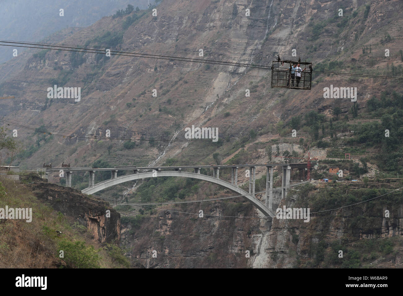 --FILE--Tourists use an aerial cableway to take a ride in an open-air ...
