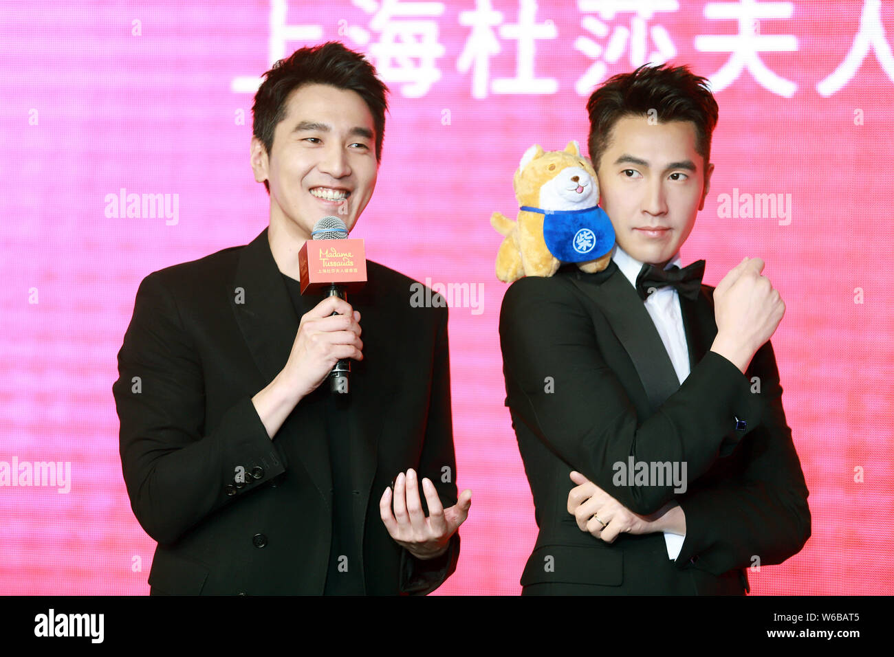 Taiwanese-Canadian actor Mark Chao, left, poses with a wax figure of ...