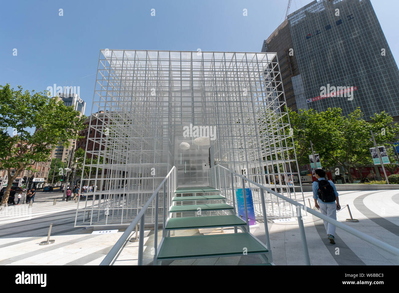 View of a white cube installation with 22 SLR cameras inside on a ...