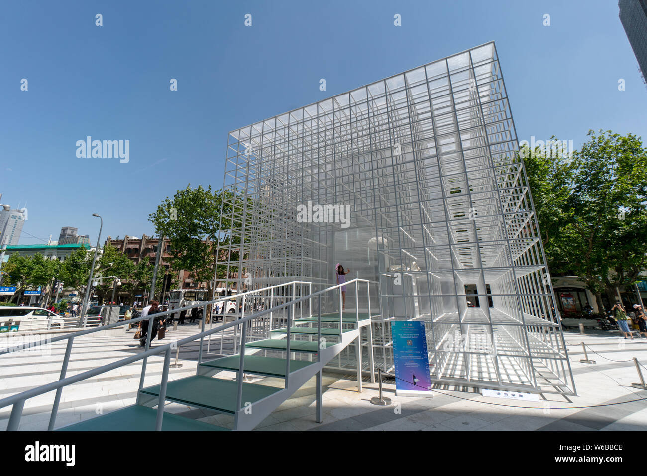 View of a white cube installation with 22 SLR cameras inside on a ...