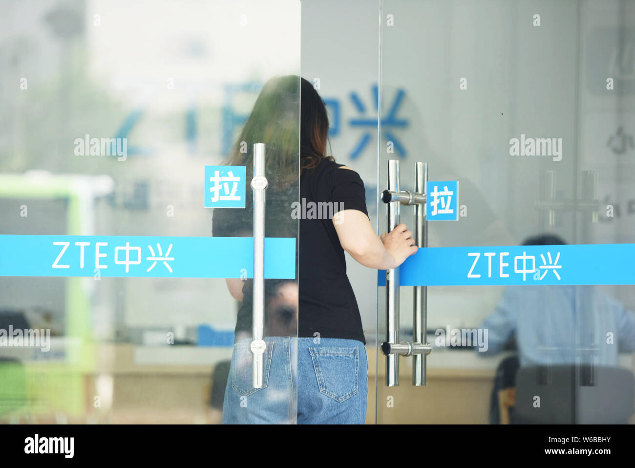 A customer enters a store of ZTE in Hangzhou city, east China's ...