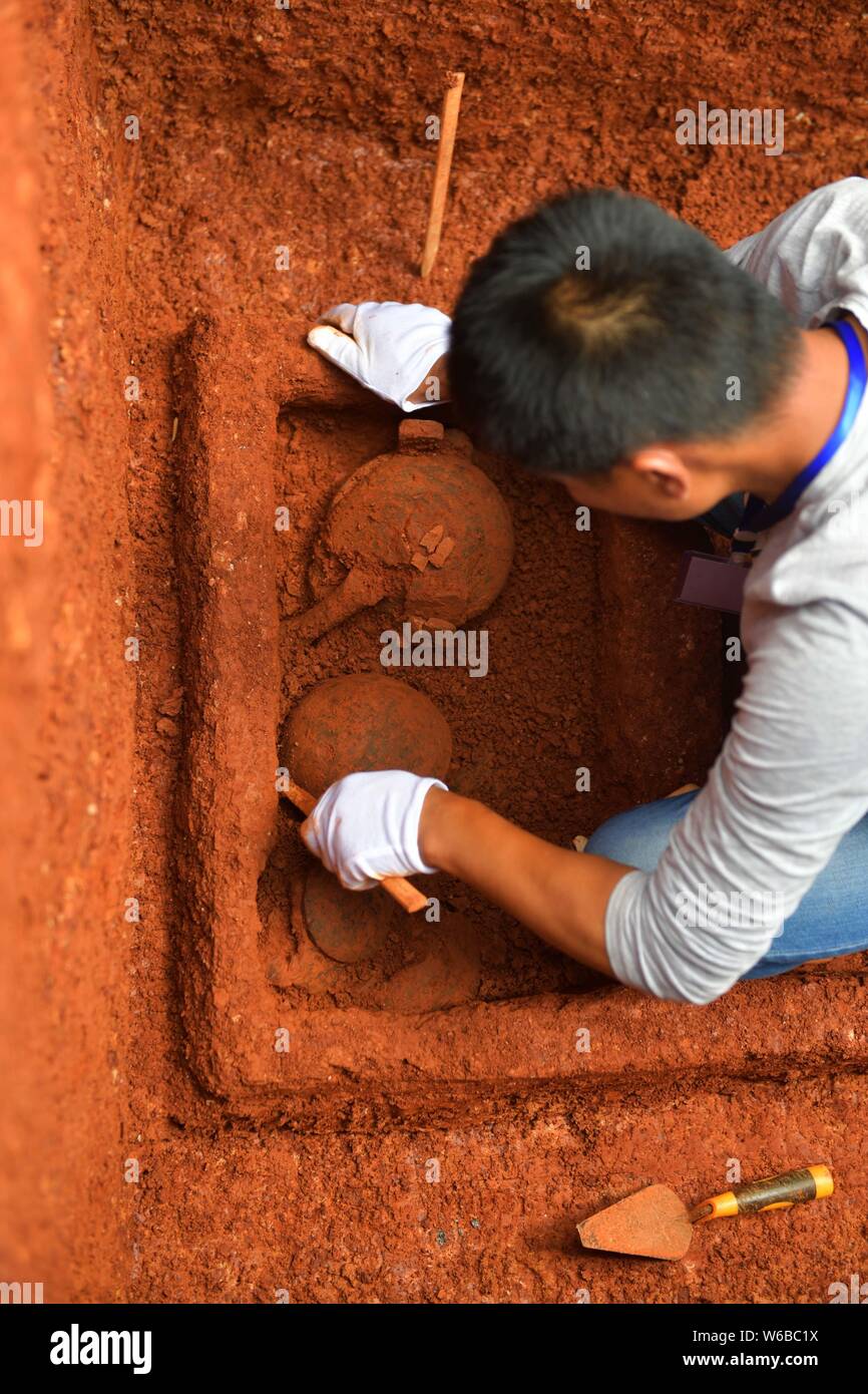 A Chinese archaeologist unearths relics from tombs, which are mainly ...