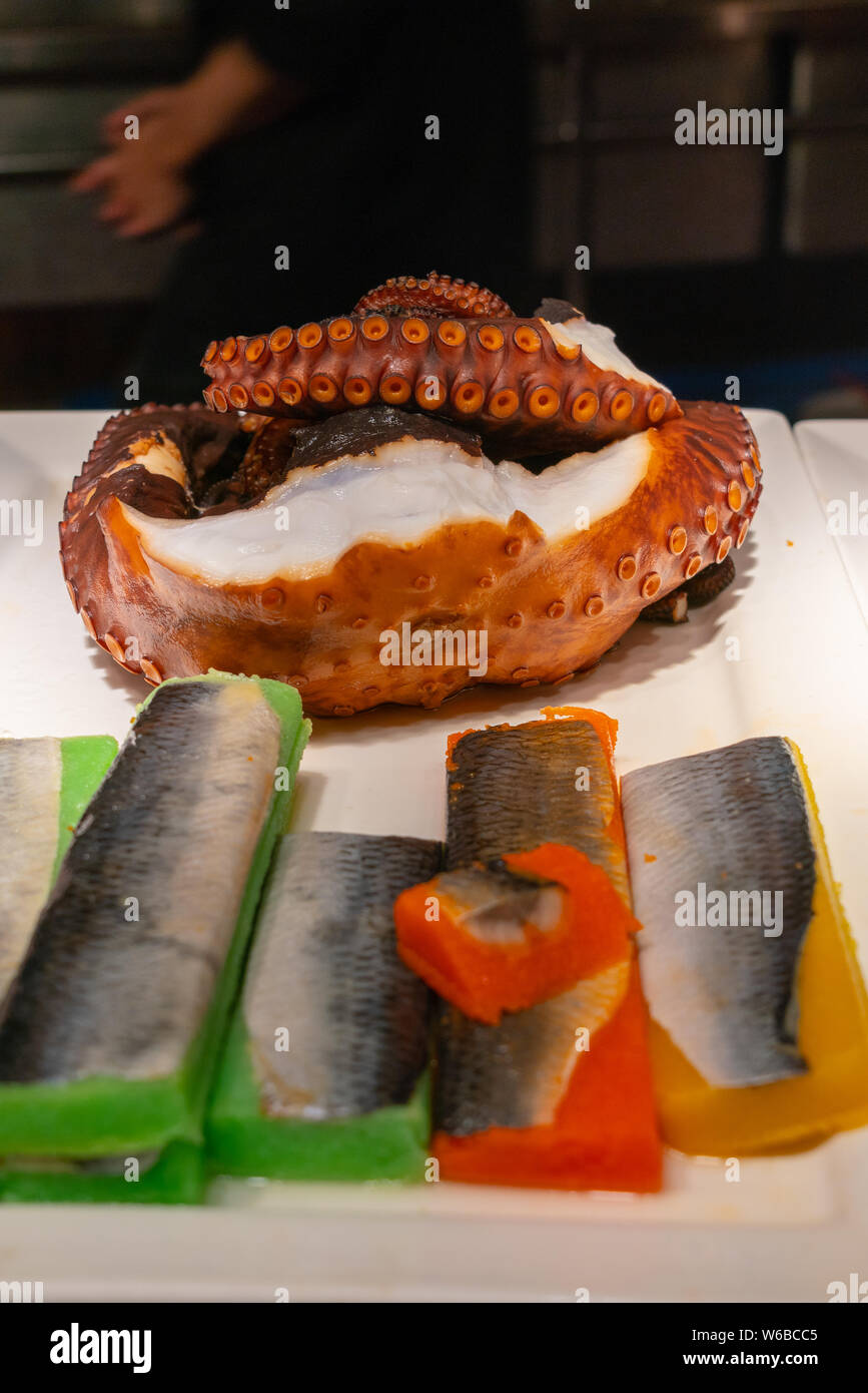 Fresh and colorful fish meat and squid in sushi restaurant Stock Photo ...