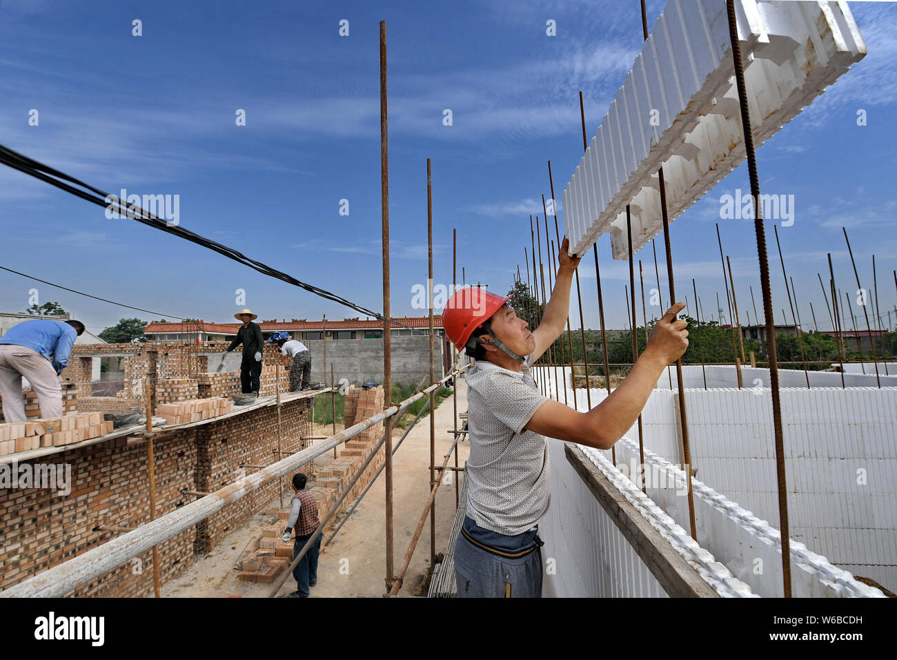 Chinese workers use expanded Polystyrene (EPS) foam to build houses in ...