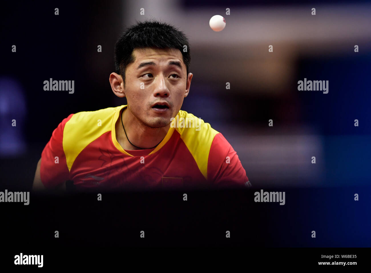 Zhang Jike of China serves against Quadri Aruna of Nigeria in their men ...