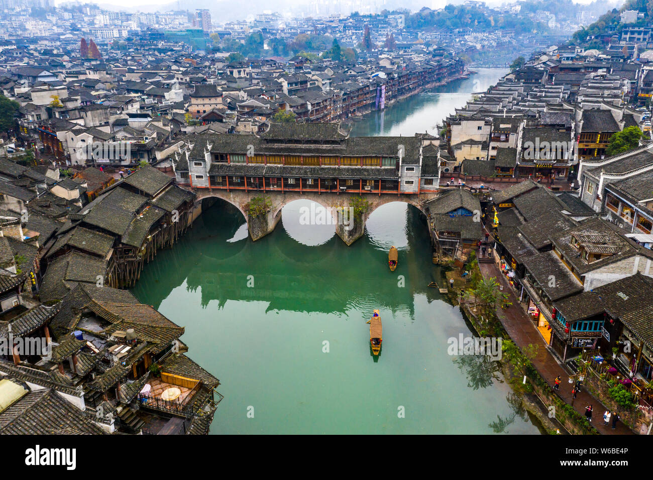 Aerial view of beautiful Fenghuang ancient town and Tuojiang river ...
