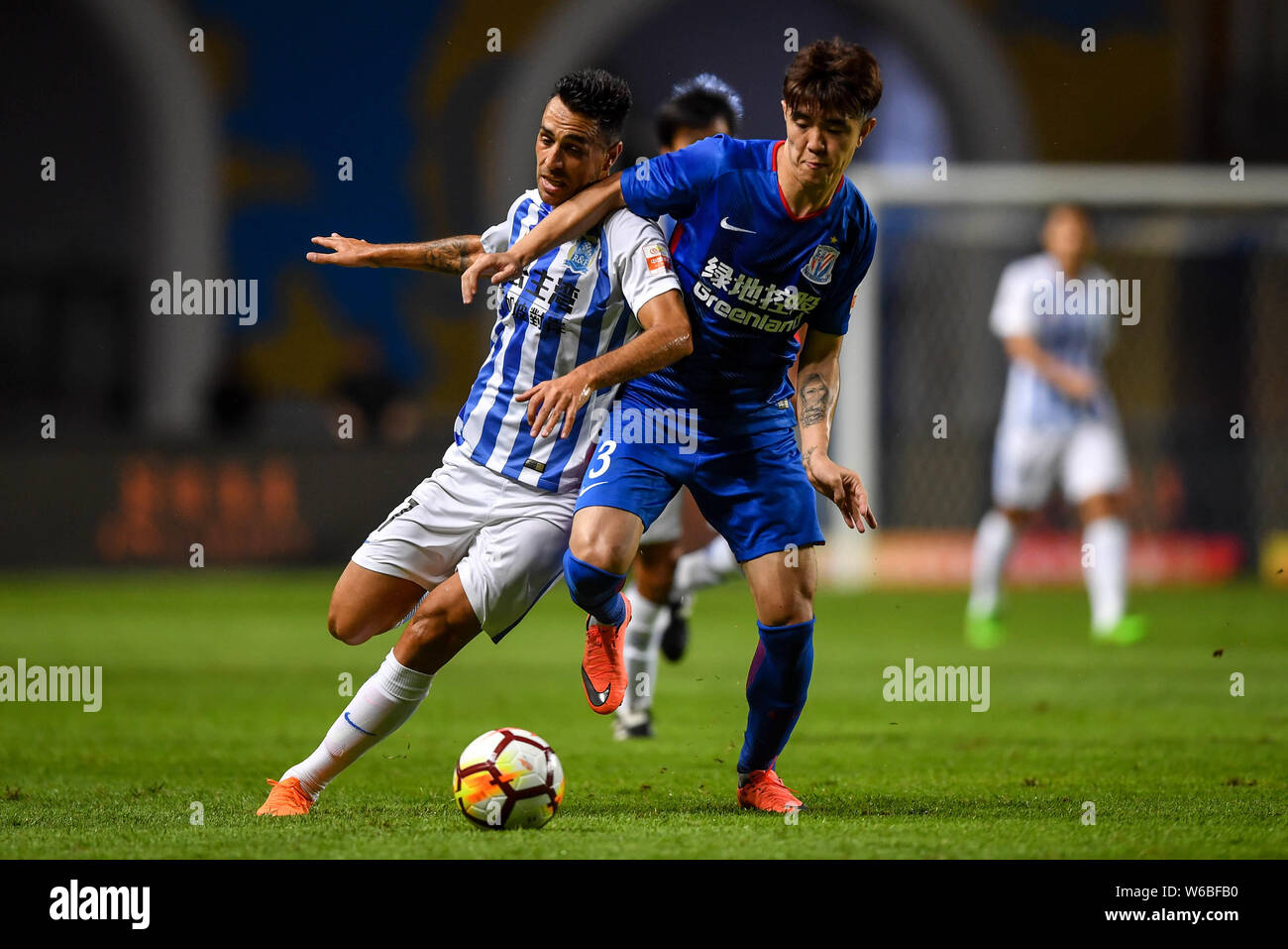 Israeli football player Eran Zahavi of Guangzhou R&F, left, challenges ...