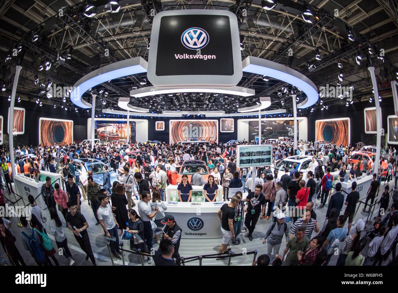 People visit the stand of Volkswagen during the 15th Beijing ...