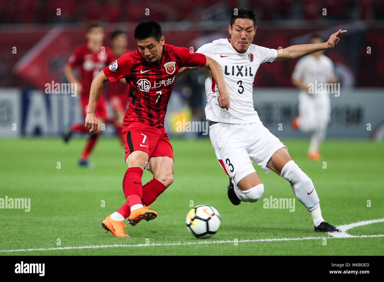 Wu Lei, left, of China's Shanghai SIPG F.C. challenges Gen Shoji of ...