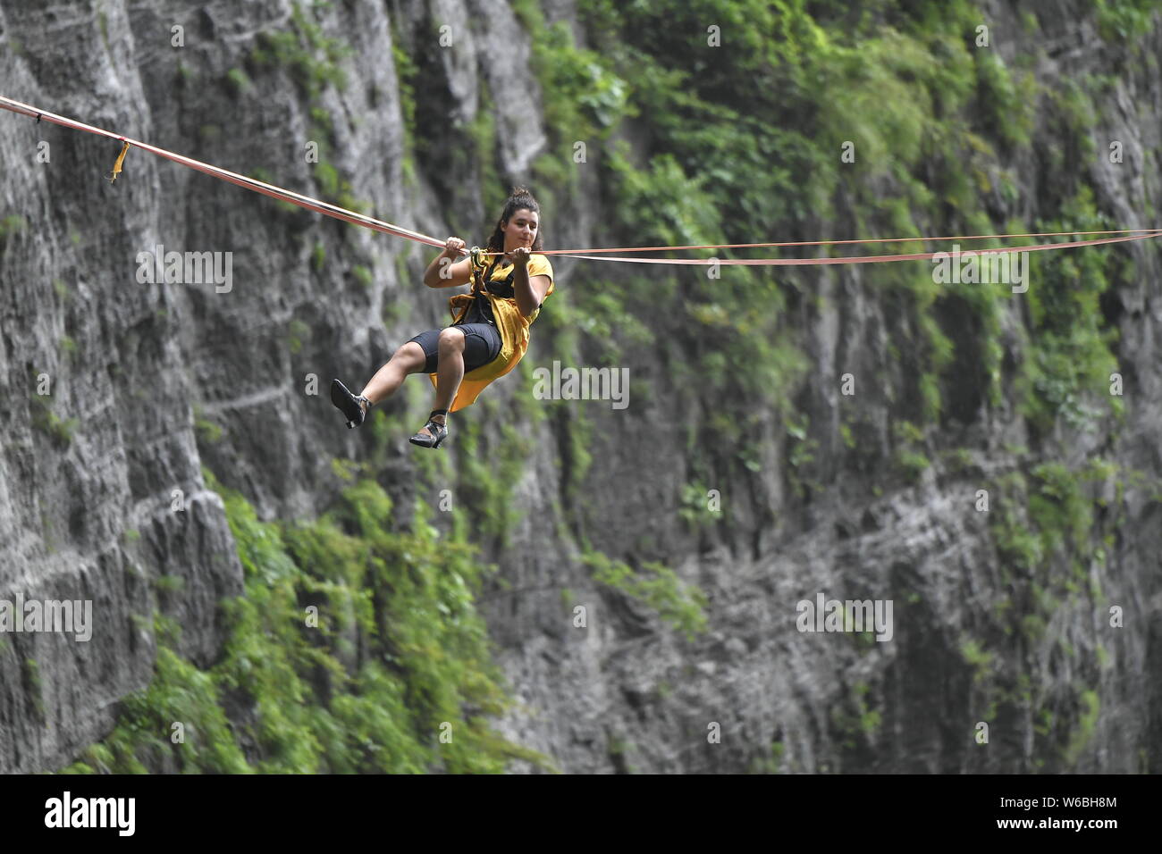Mia Noblet of Canada participates in a slackline contest in high heels ...