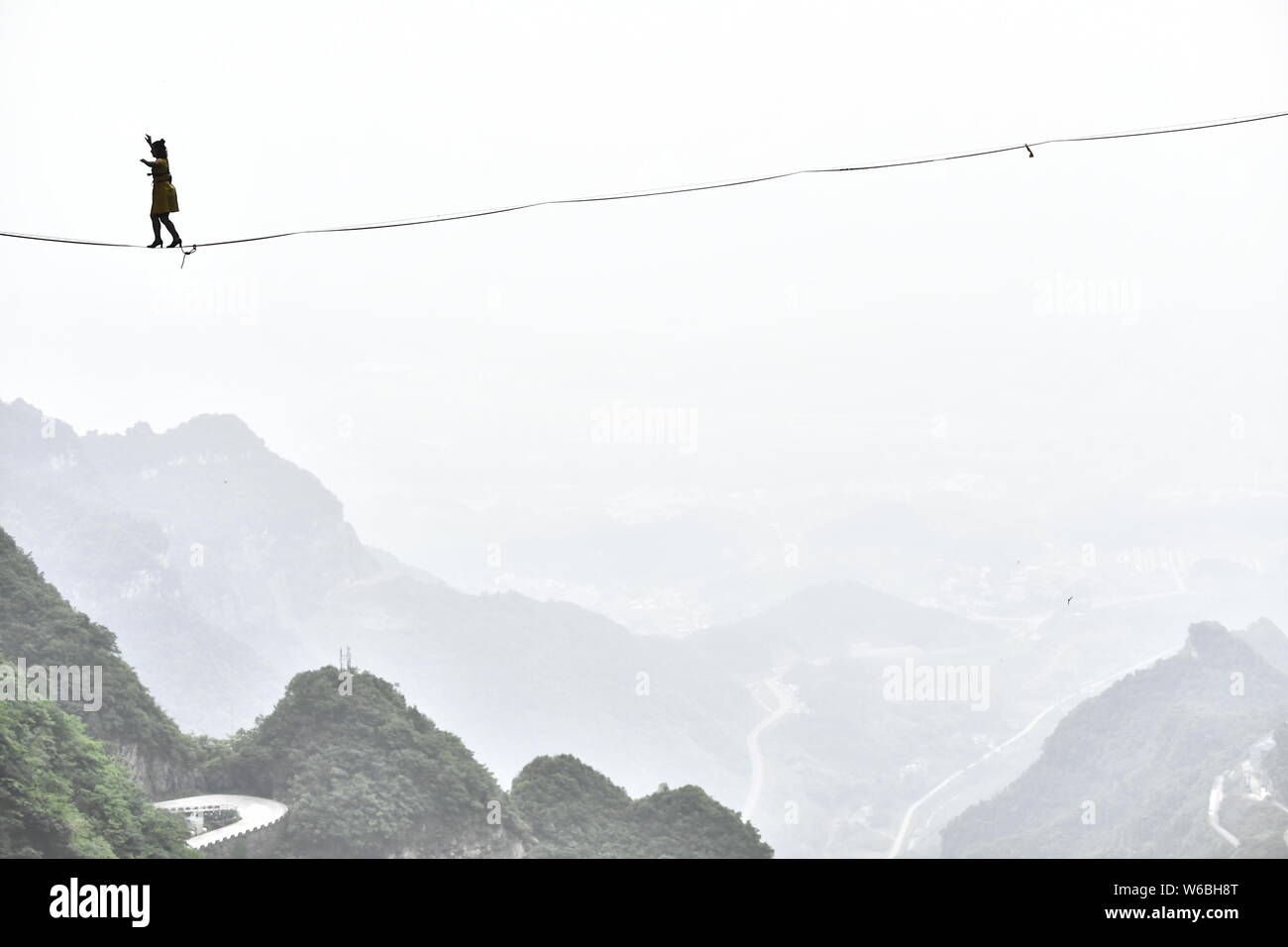 Mia Noblet of Canada participates in a slackline contest in high heels ...