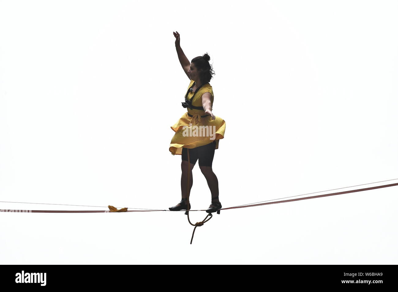 Mia Noblet of Canada participates in a slackline contest in high heels ...