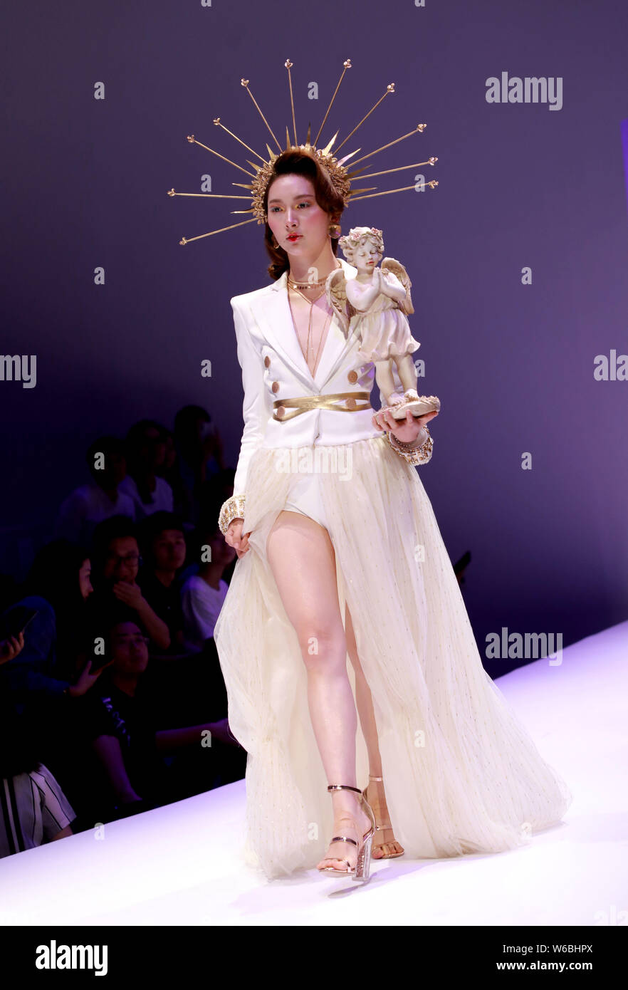 A model displays a creation by a graduate during a fashion show for ...