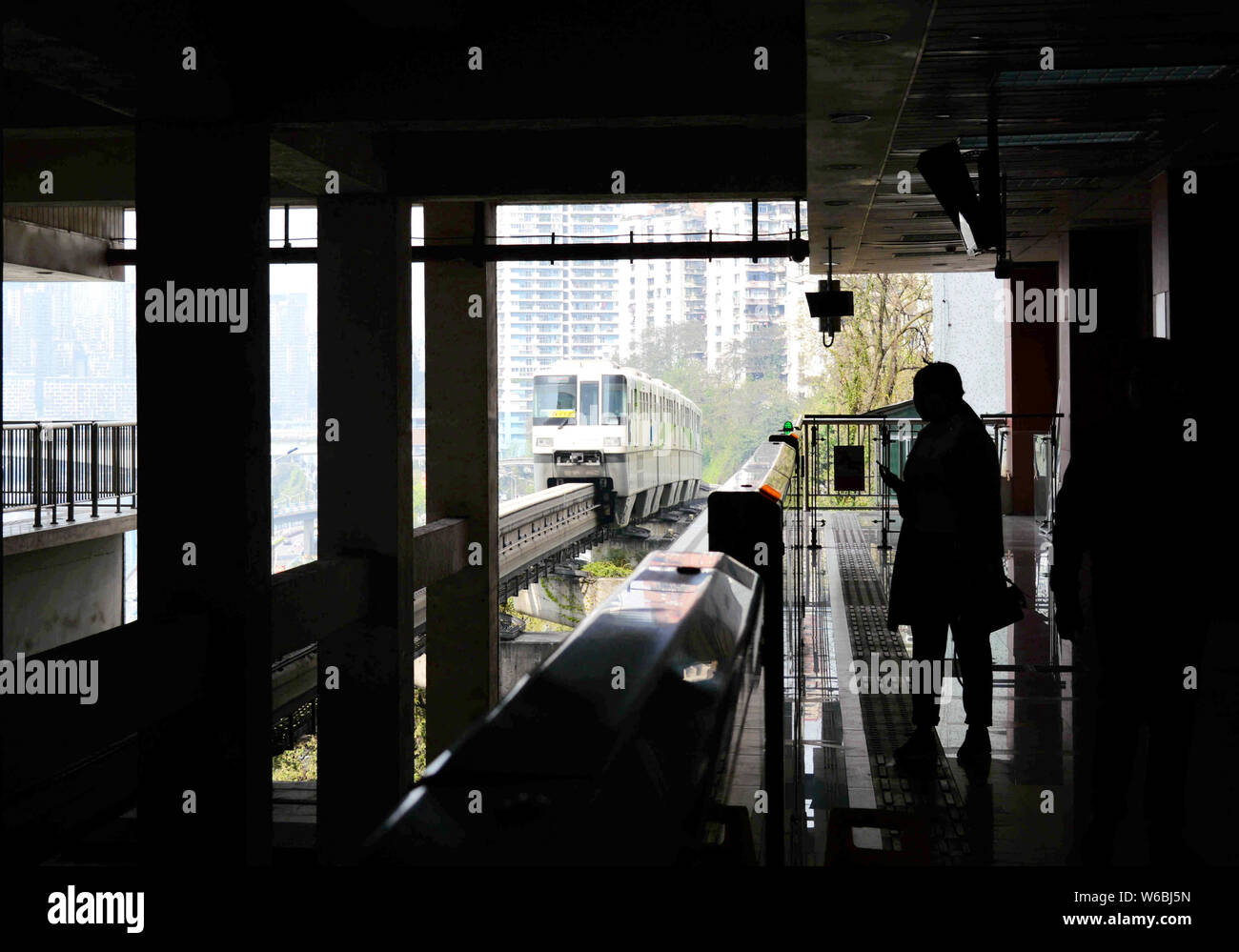 The No.2 light-rail train drives through a building in Liziba Station ...