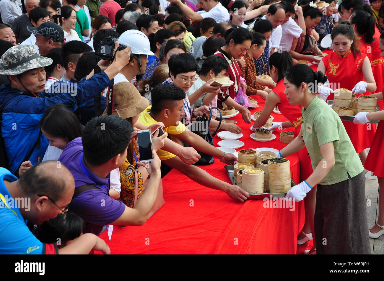 Local residents try out the 1,098 steamed dishes heated in a giant food ...