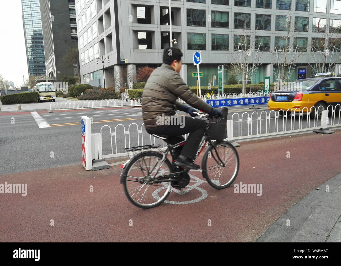 --FILE--A cyclist rides on a bicycle lane in a street in Beijing, China ...