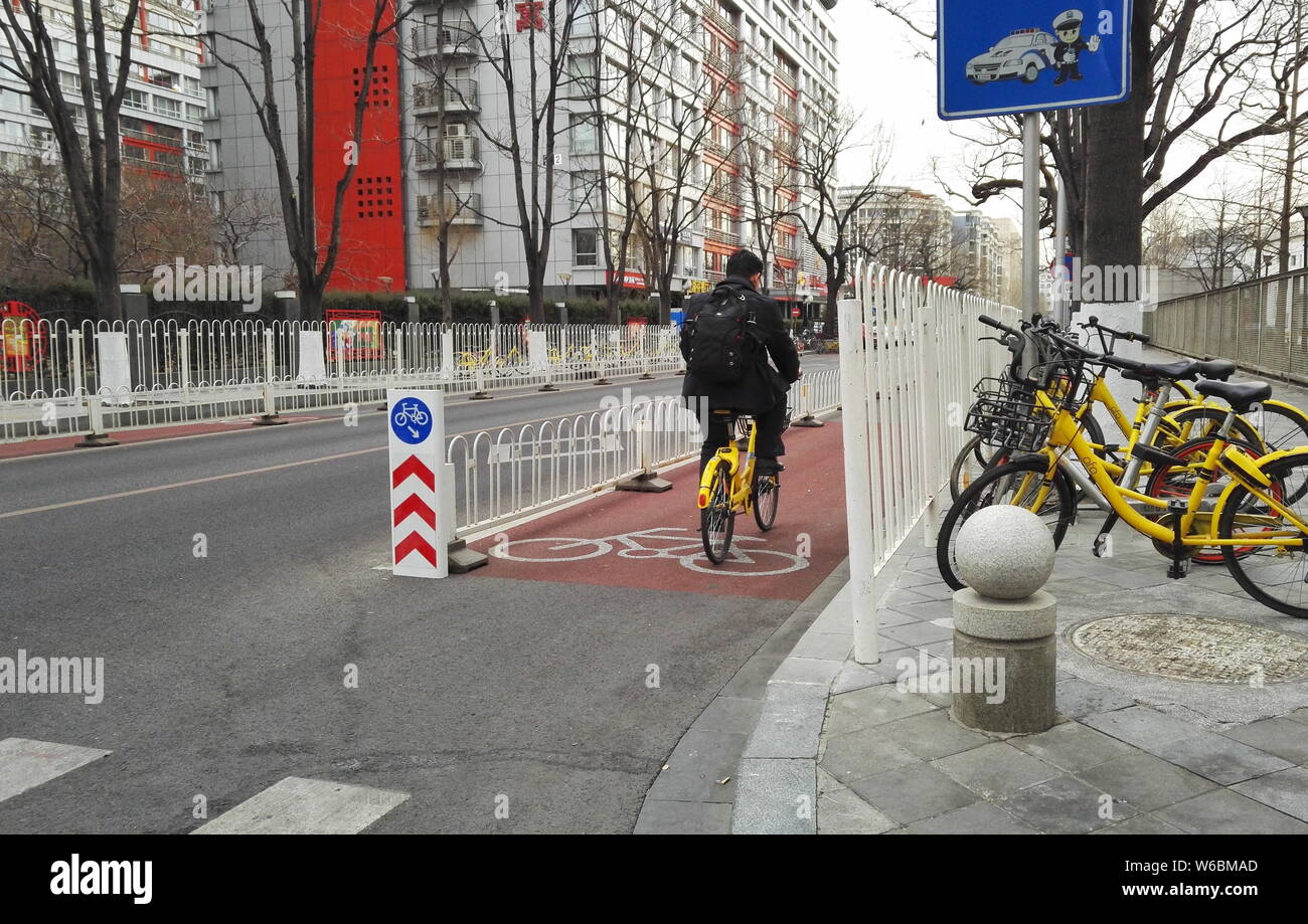 --FILE--A cyclist rides on a bicycle lane in a street in Beijing, China ...