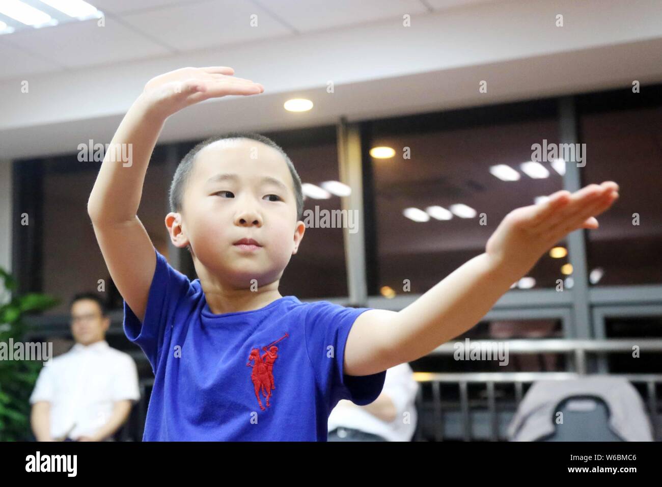A learner practises Chinese Beijing Opera or Peking Opera with the help ...