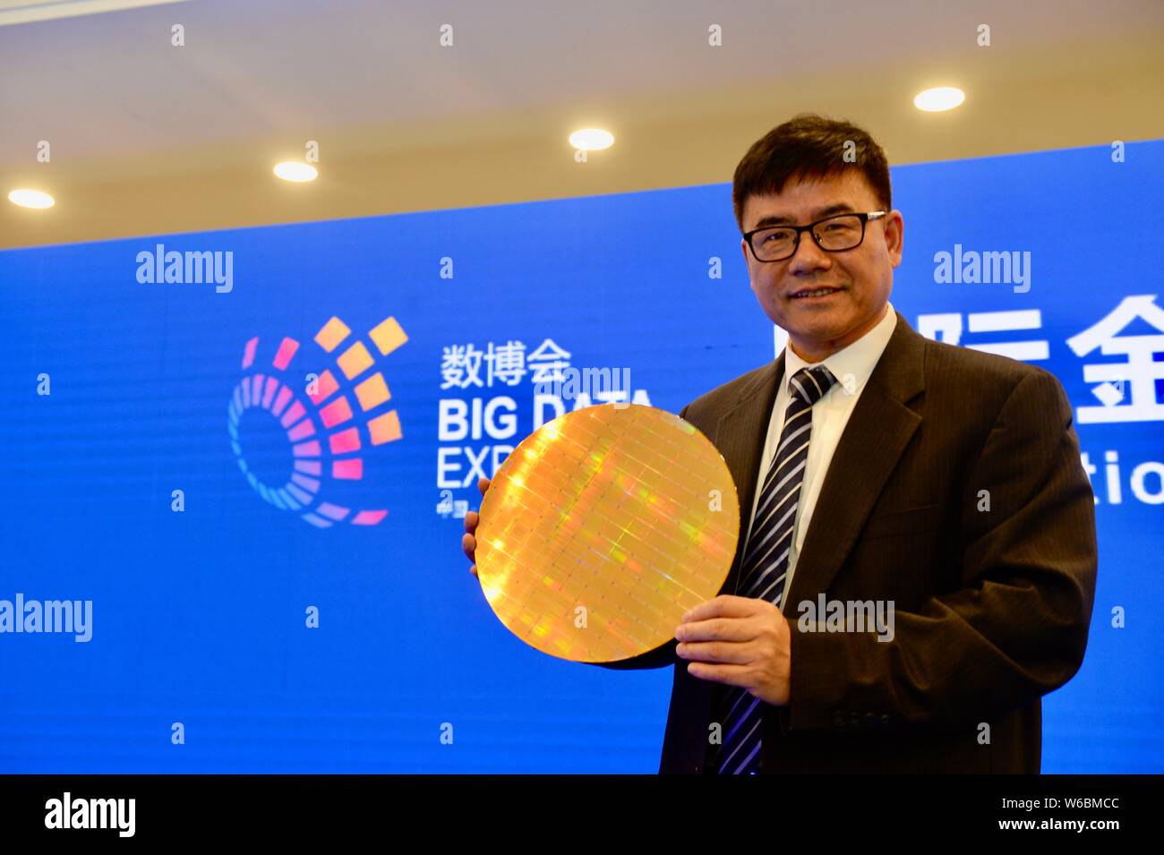 A Chinese employee shows a wafer for "StarDragon" 48 core processor ...