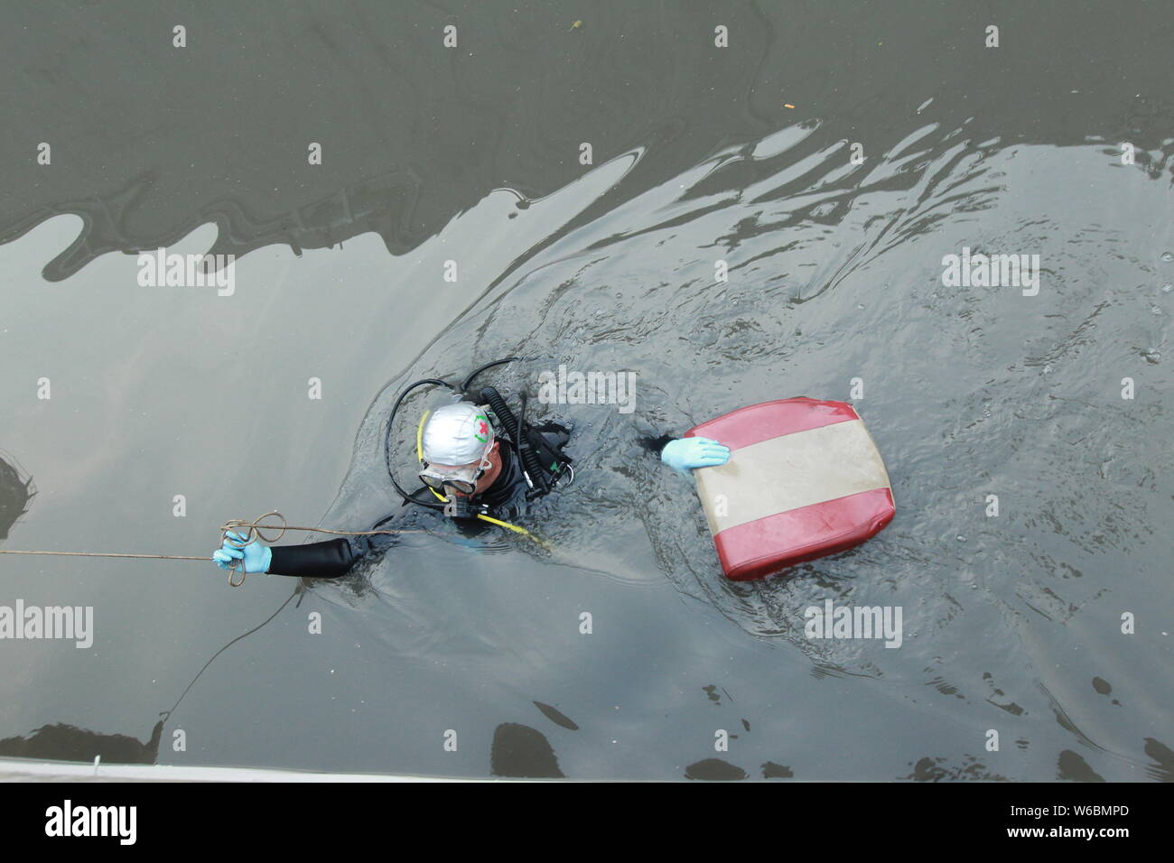 A member of rescue team from Zhengzhou Red Cross conducts an underwater ...