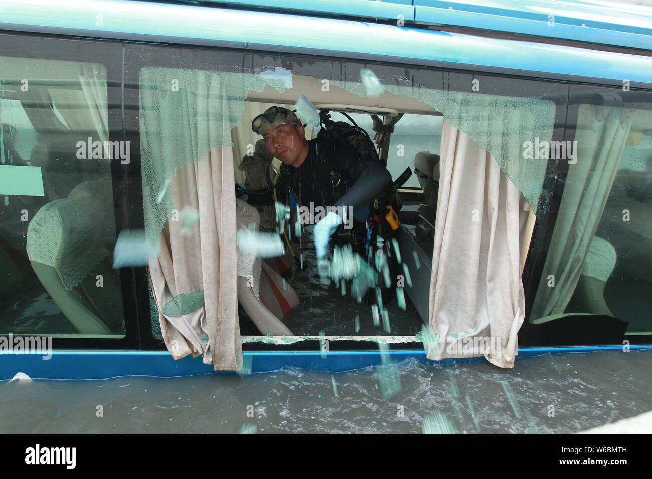 A member of rescue team from Zhengzhou Red Cross conducts an underwater ...
