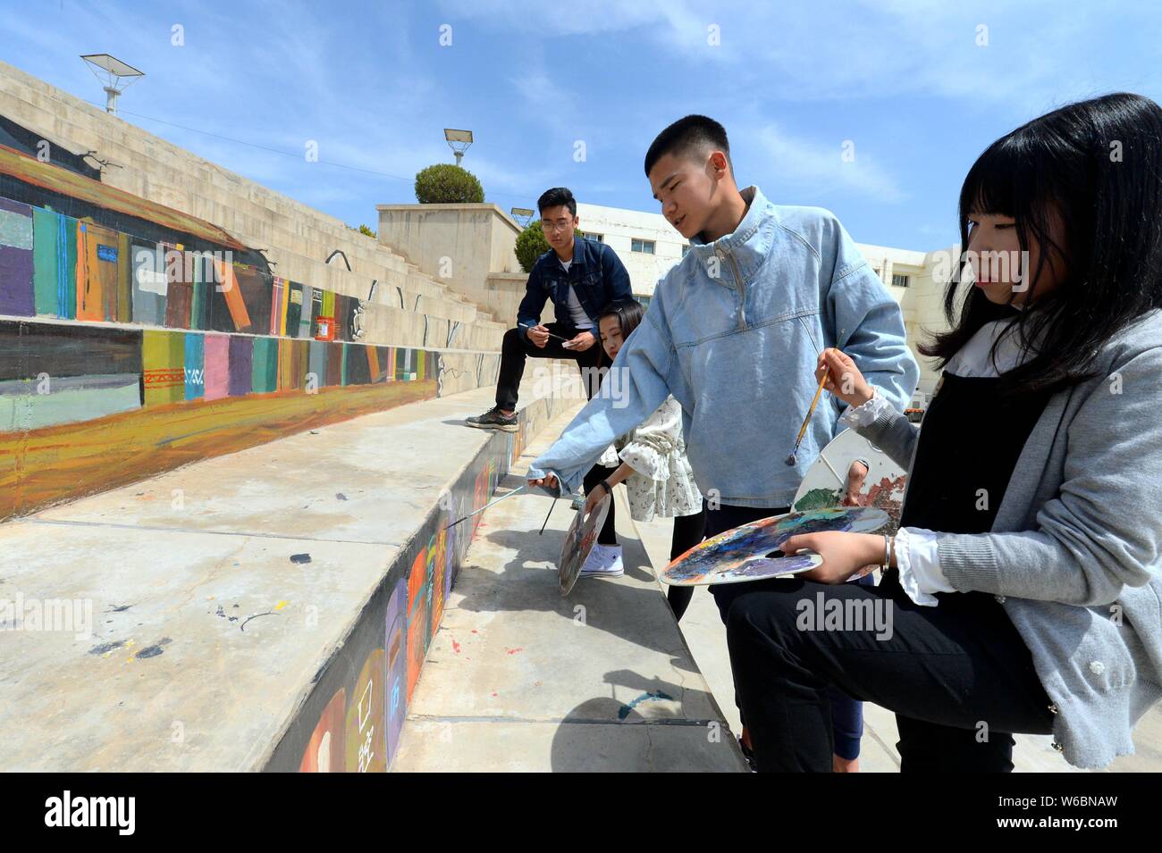 Students create a 3D painting of a library on a staircase at Lanzhou ...