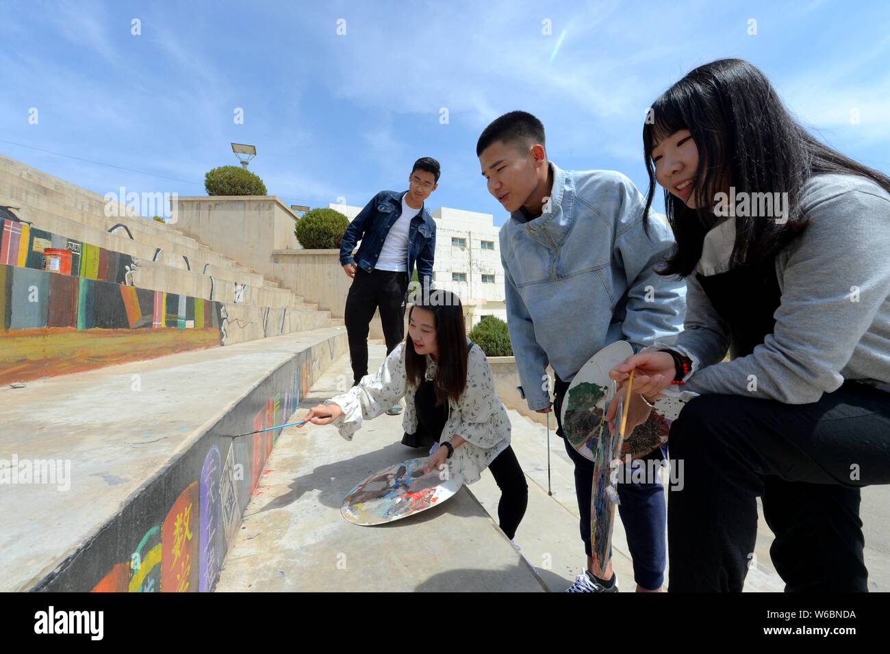 Students create a 3D painting of a library on a staircase at Lanzhou ...
