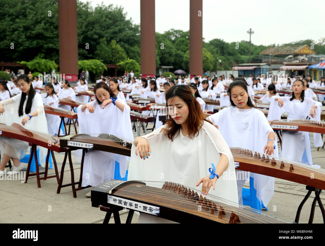 Chinese people perform traditional Chinese instrument Guzheng during a ...
