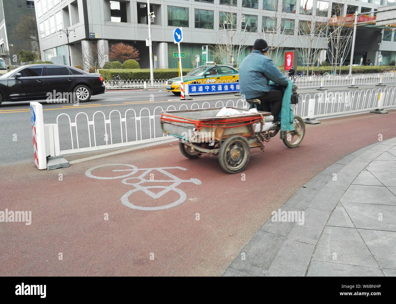 --FILE--A cyclist rides on a bicycle lane in a street in Beijing, China ...