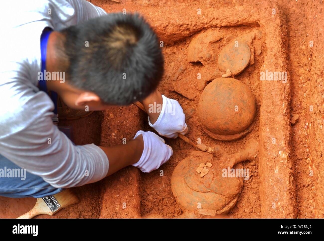 A Chinese archaeologist unearths relics from tombs, which are mainly ...
