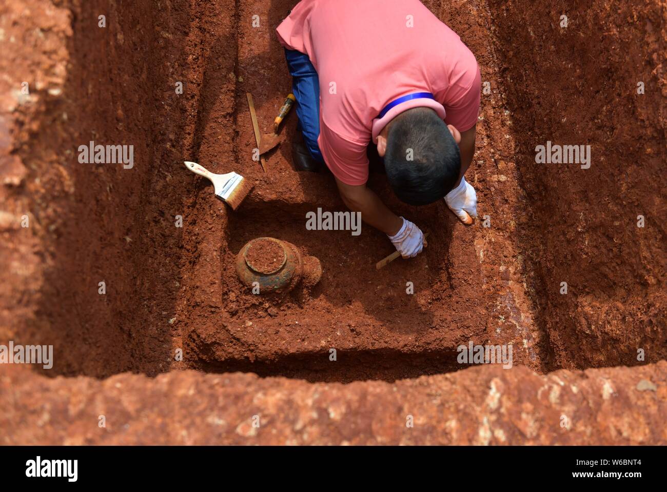 A Chinese archaeologist unearths relics from tombs, which are mainly ...