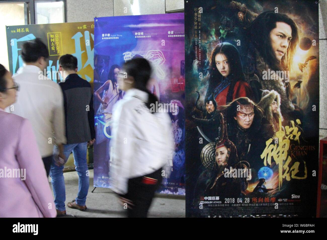 --FILE--Chinese moviegoers walks past posters for films at a cinema in ...