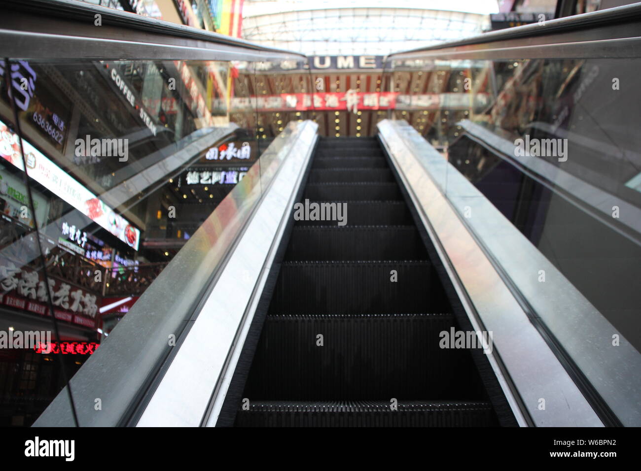 A mini escalator, too narrow for people to stand side by side, is seen ...
