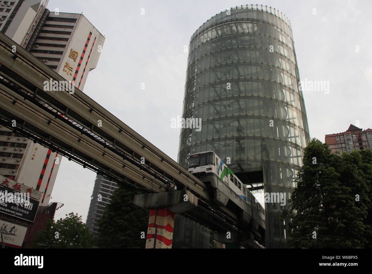 A monorail train of Chongqing Light Rail Line passes through a glass ...