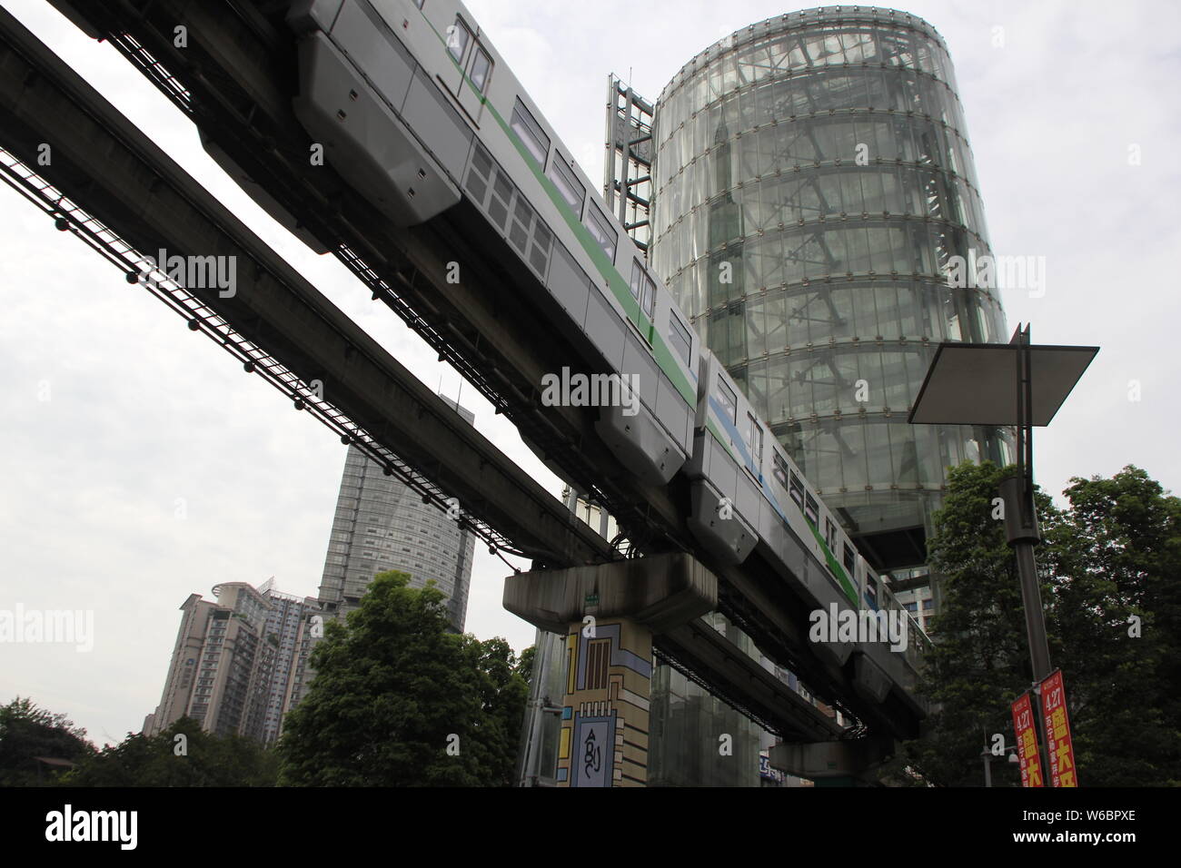A monorail train of Chongqing Light Rail Line passes through a glass ...