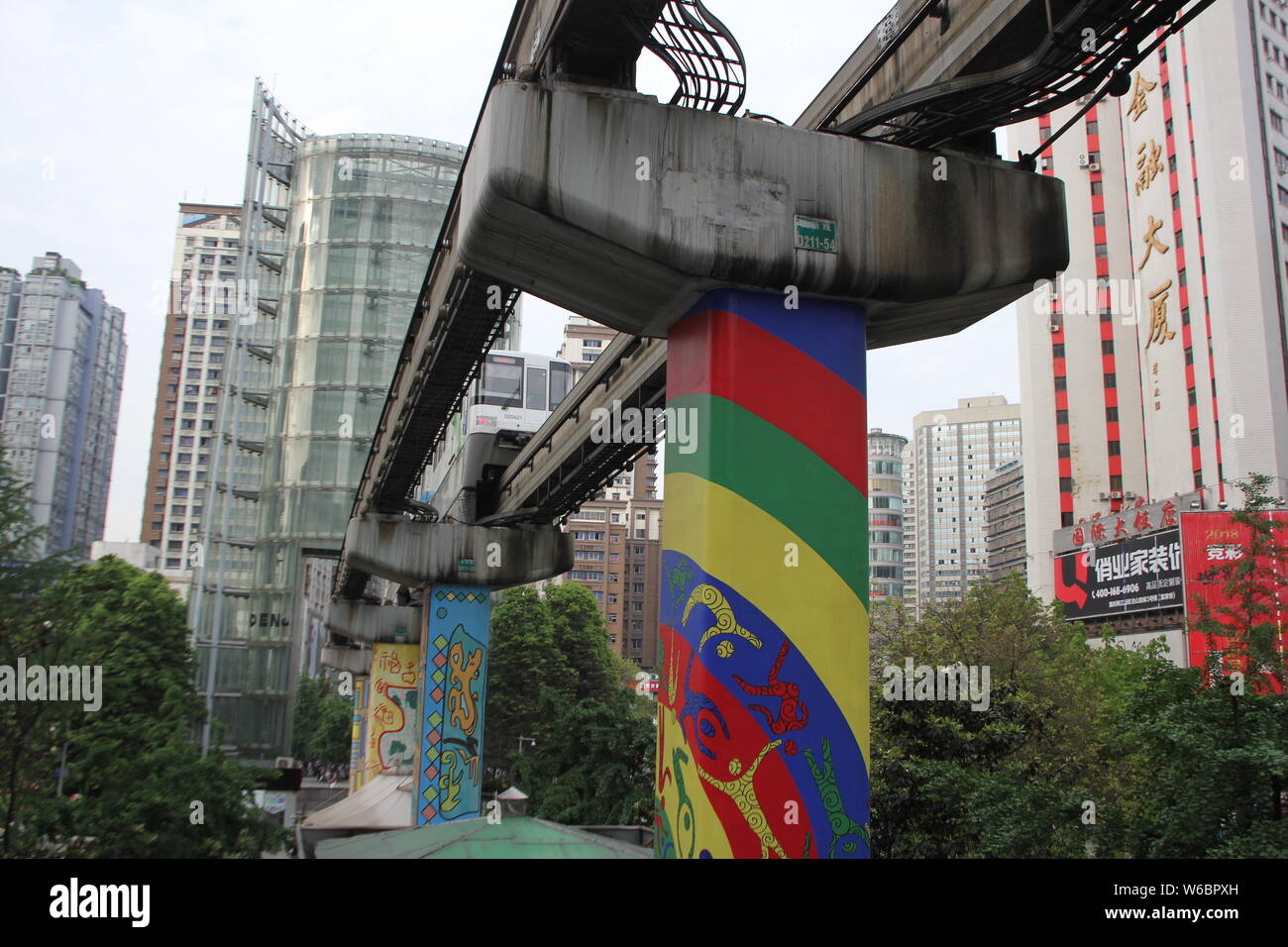 A monorail train of Chongqing Light Rail Line passes through a glass ...
