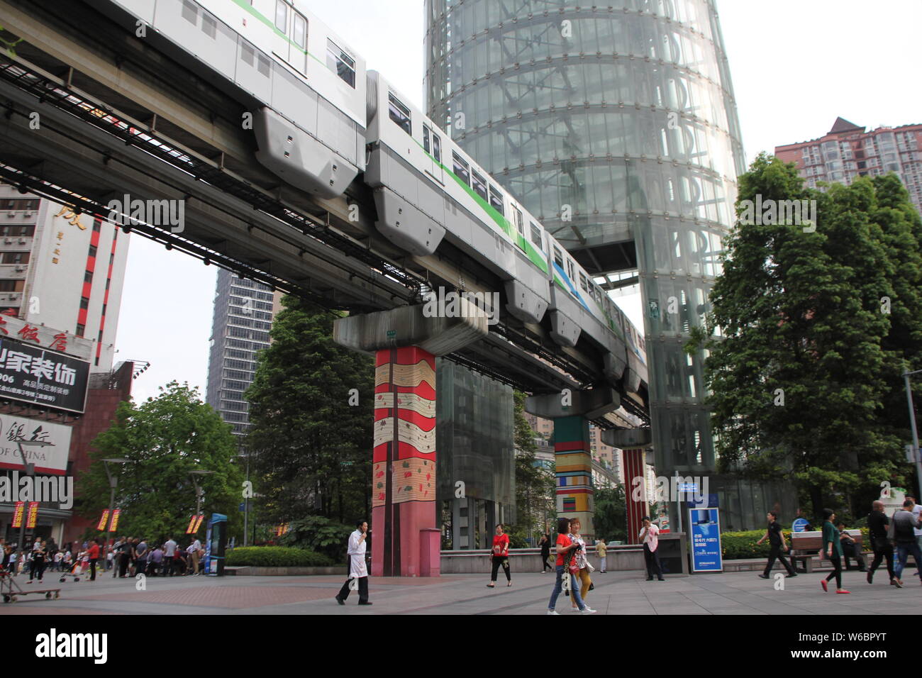 A monorail train of Chongqing Light Rail Line passes through a glass ...