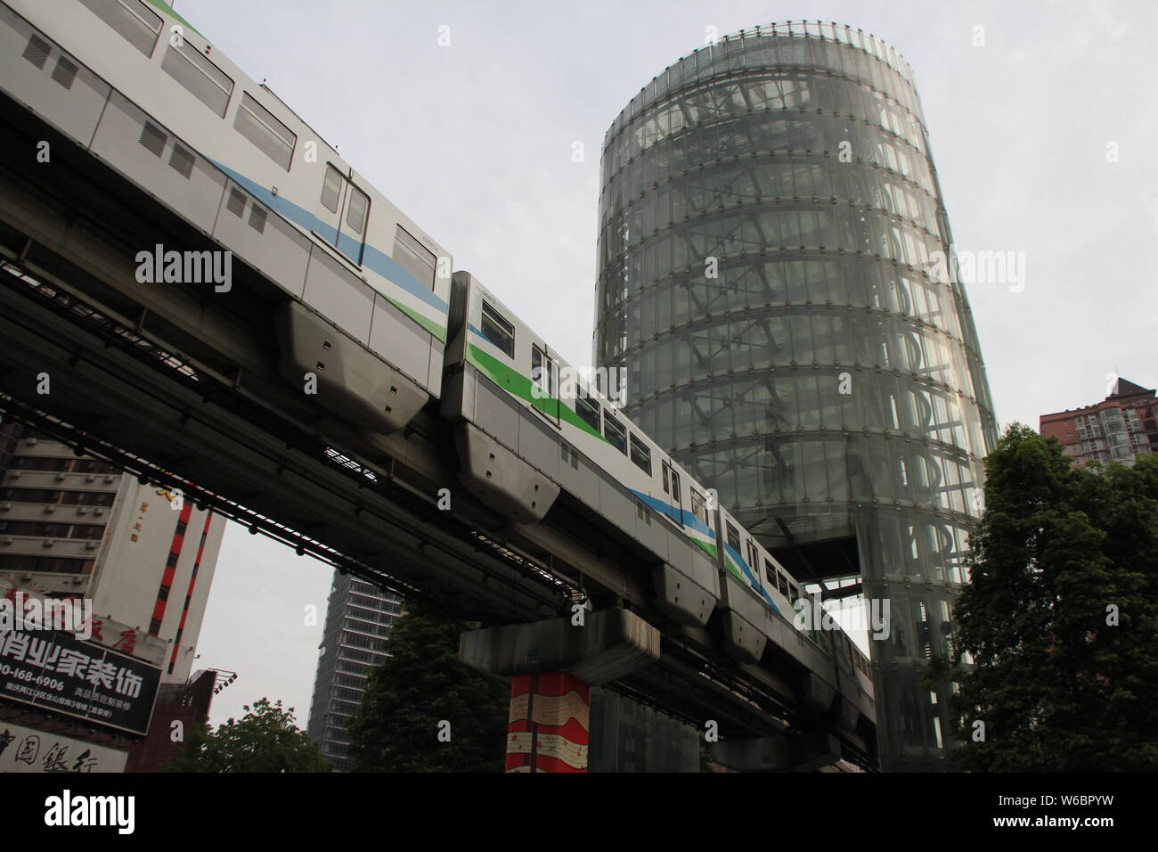 A monorail train of Chongqing Light Rail Line passes through a glass ...