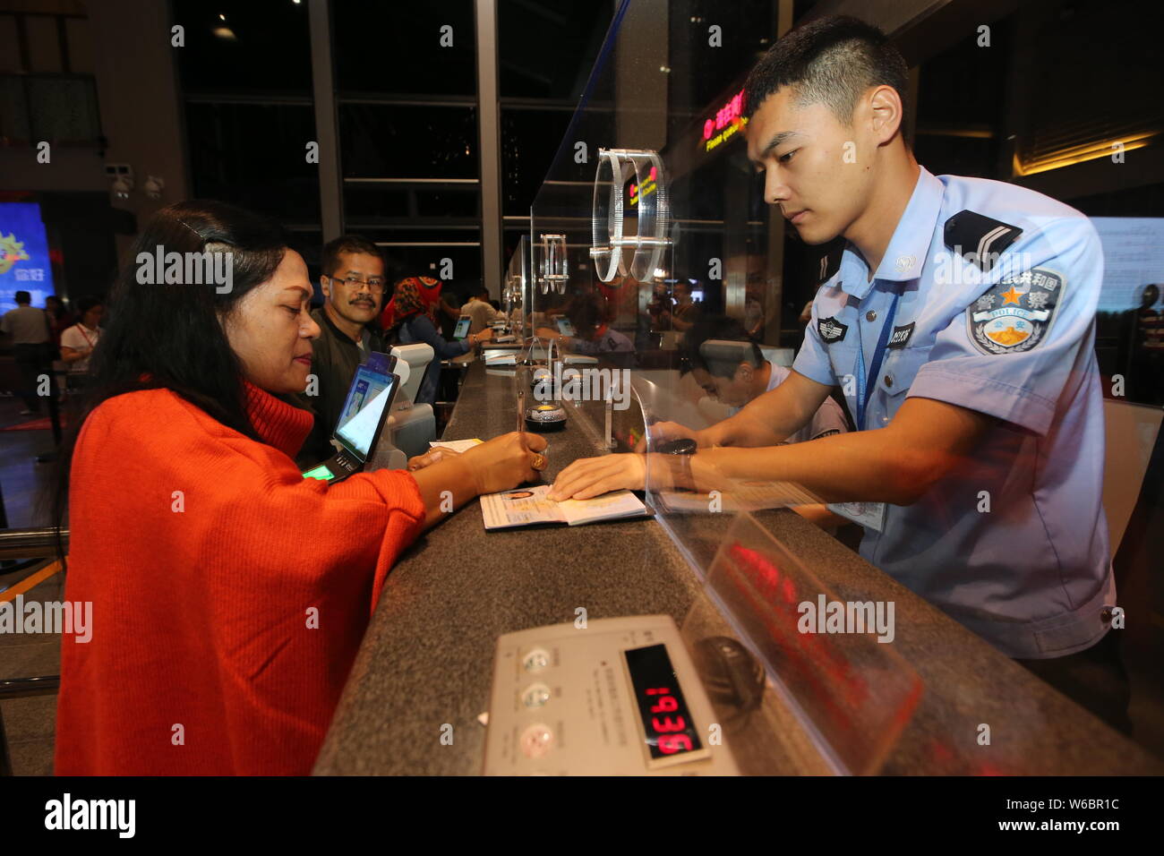 Indonesian tourists receive immigration inspection at the Haikou Meilan ...