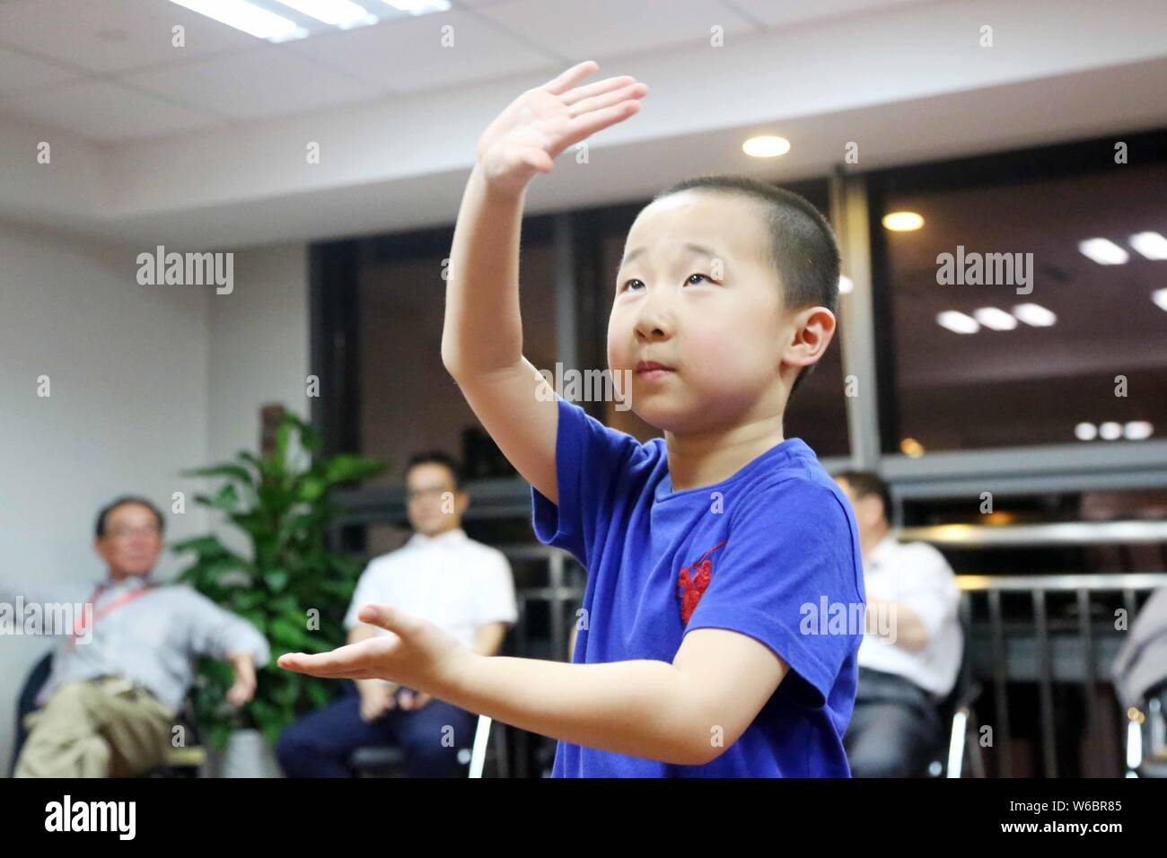 A learner practises Chinese Beijing Opera or Peking Opera with the help ...