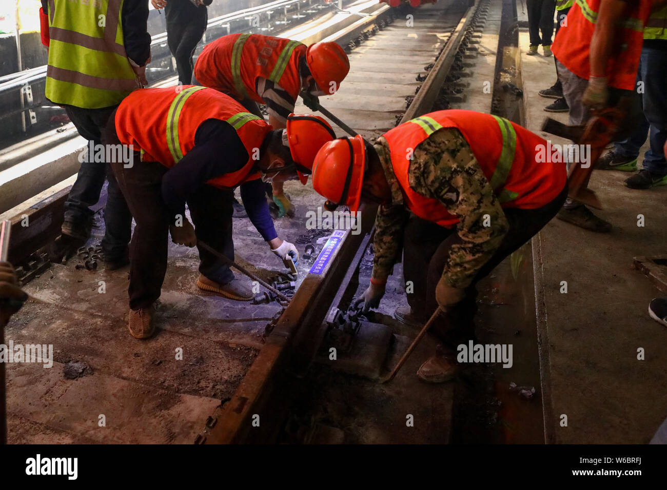 Chinese workers labor at the track construction site of the second and ...
