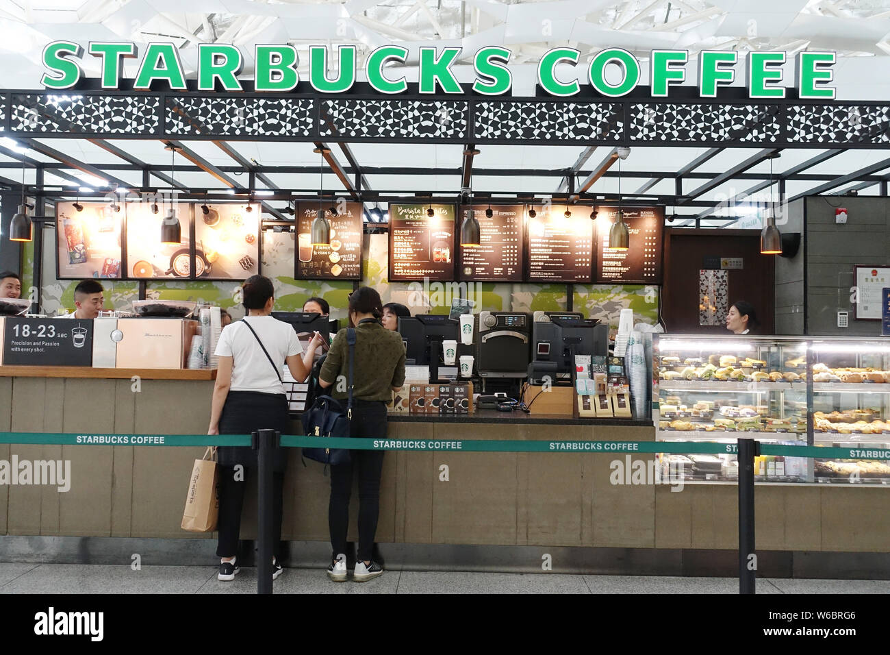 --FILE--Customers shop in a cafe of Starbucks Coffee in Shanghai, China ...
