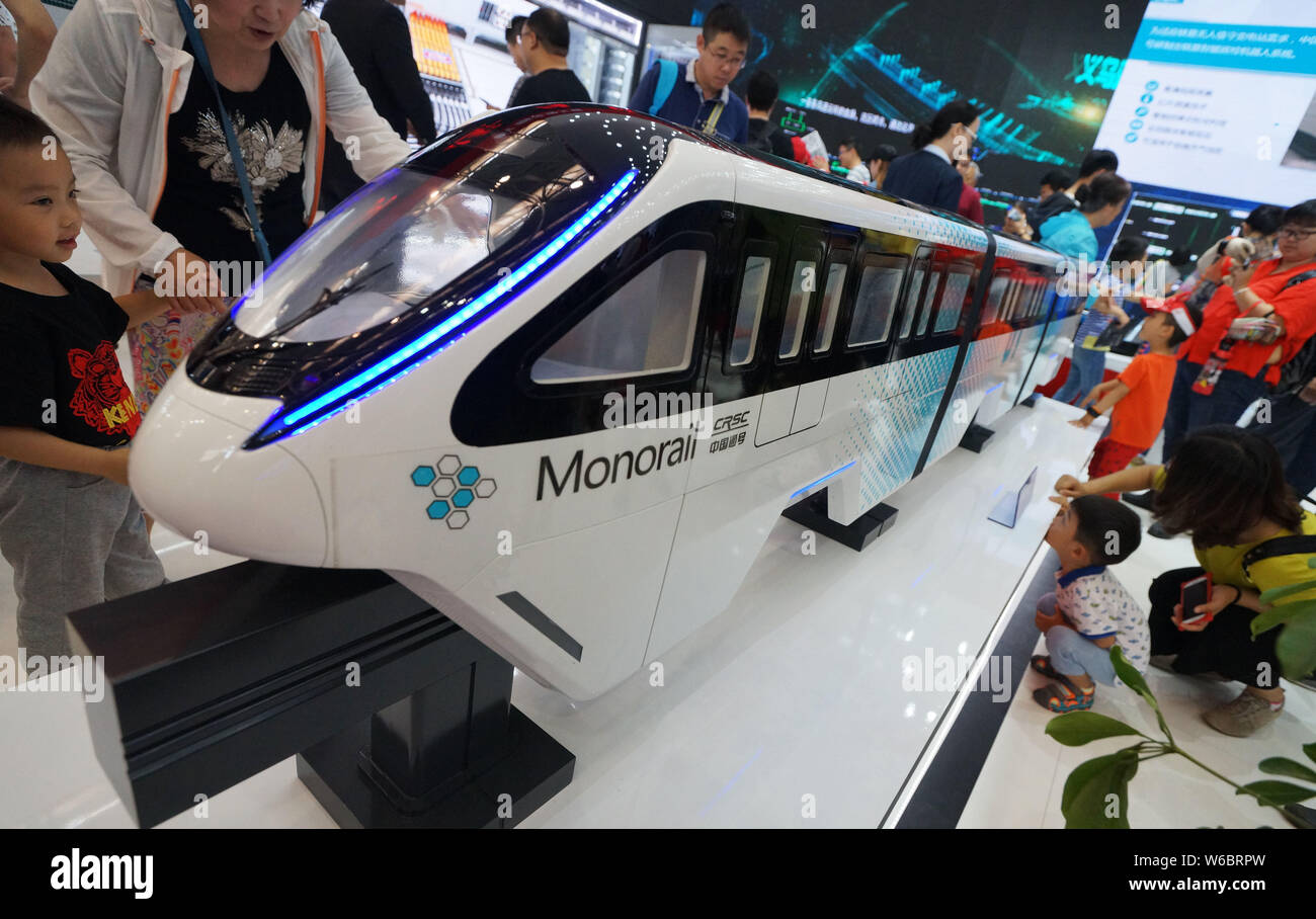 Vistiors look at a new driverless carbon-fiber monorail train ...