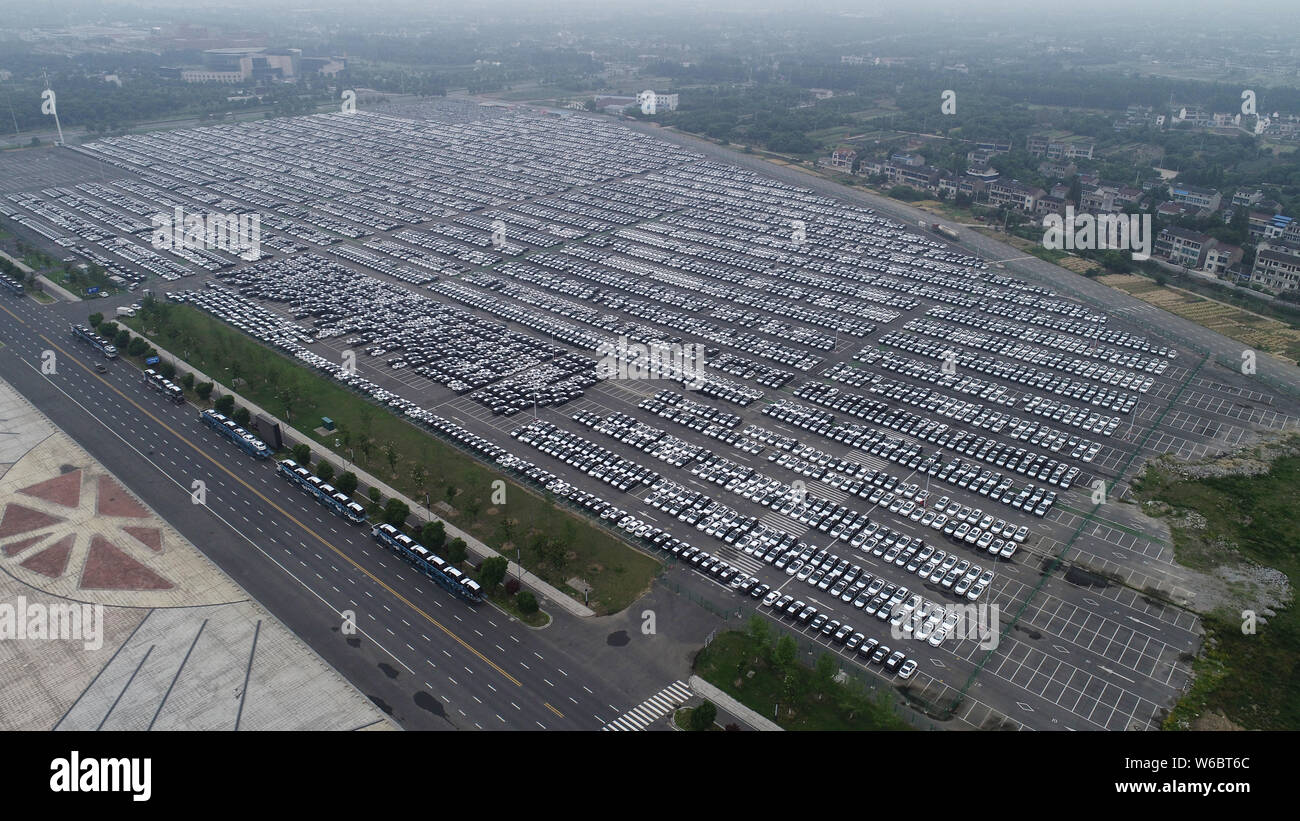 Aerial view of massive vehicles filling a parking lot in rows in ...