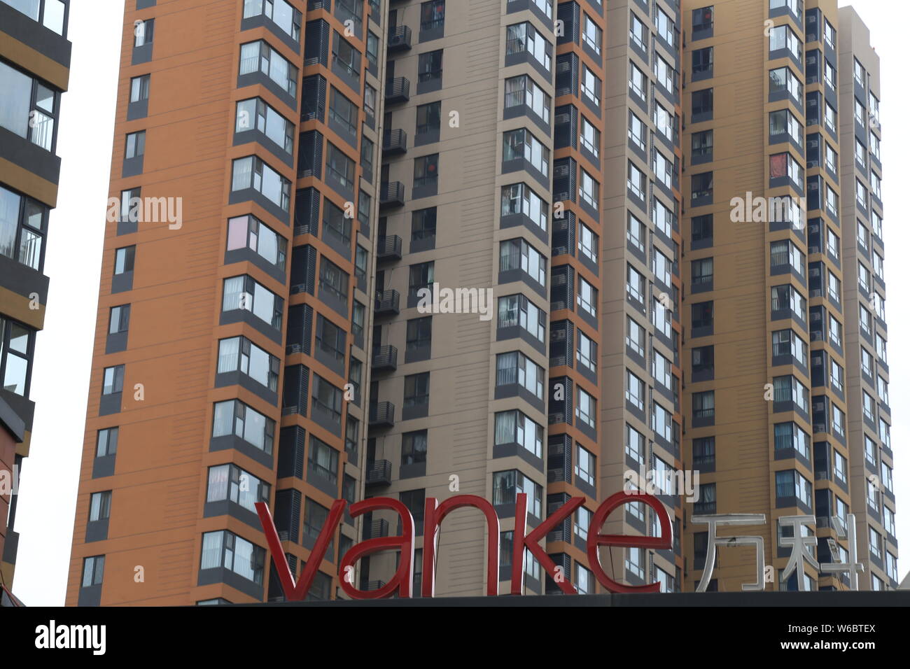 A logo of Vanke is seen on the rooftop of a building at a residential ...