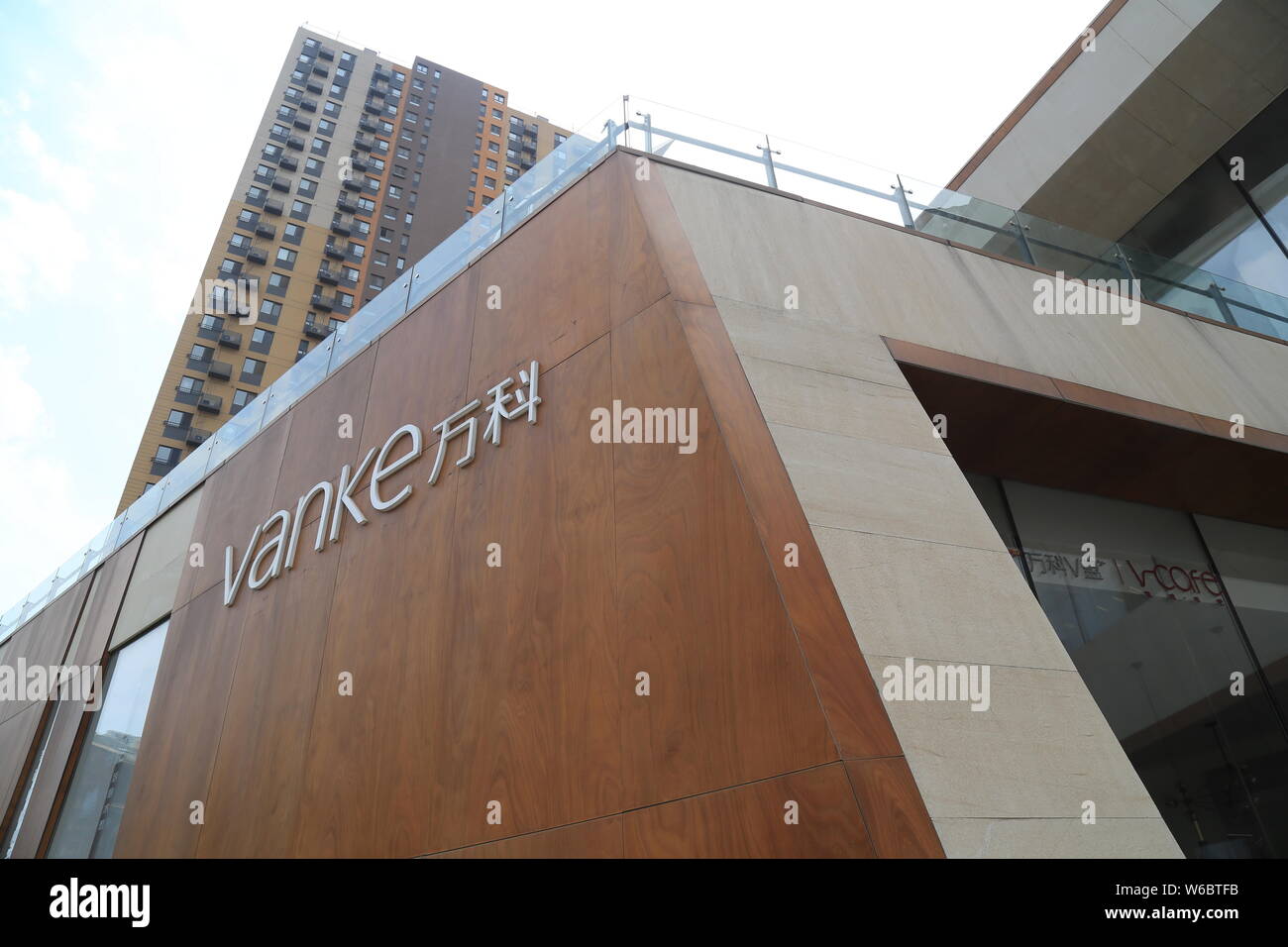 A logo of Vanke is seen on a building at a residential quarter ...