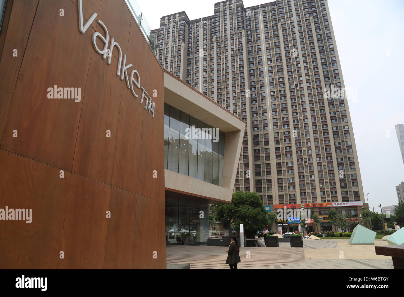 A logo of Vanke is seen on a building at a residential quarter ...